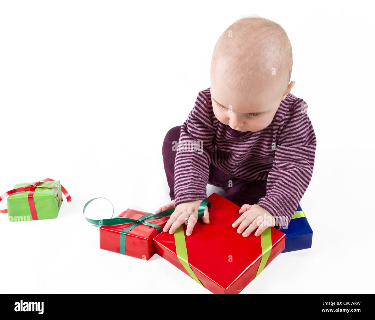young child unpacking red present. white background. single person ...