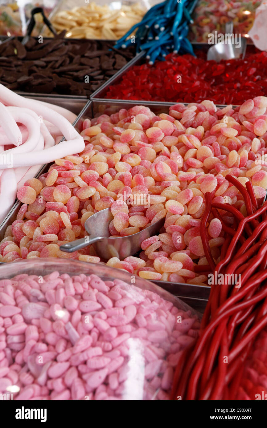 A wide selection of sweets or candy displayed on a table in a market ...