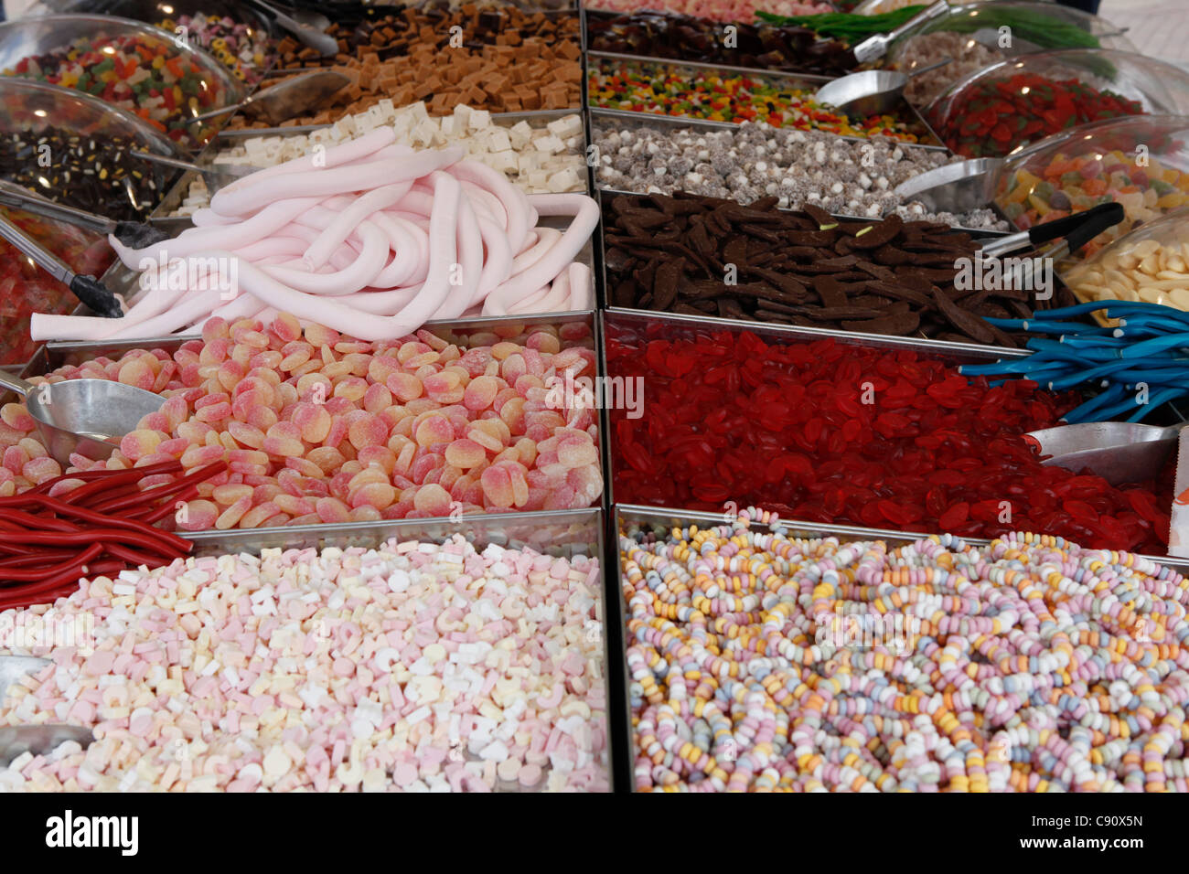 A wide selection of sweets or candy displayed on a table in a market ...