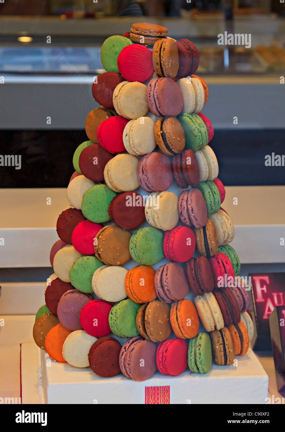 Display of colourful macaroons in the window of a Paris shop. Sweet ...