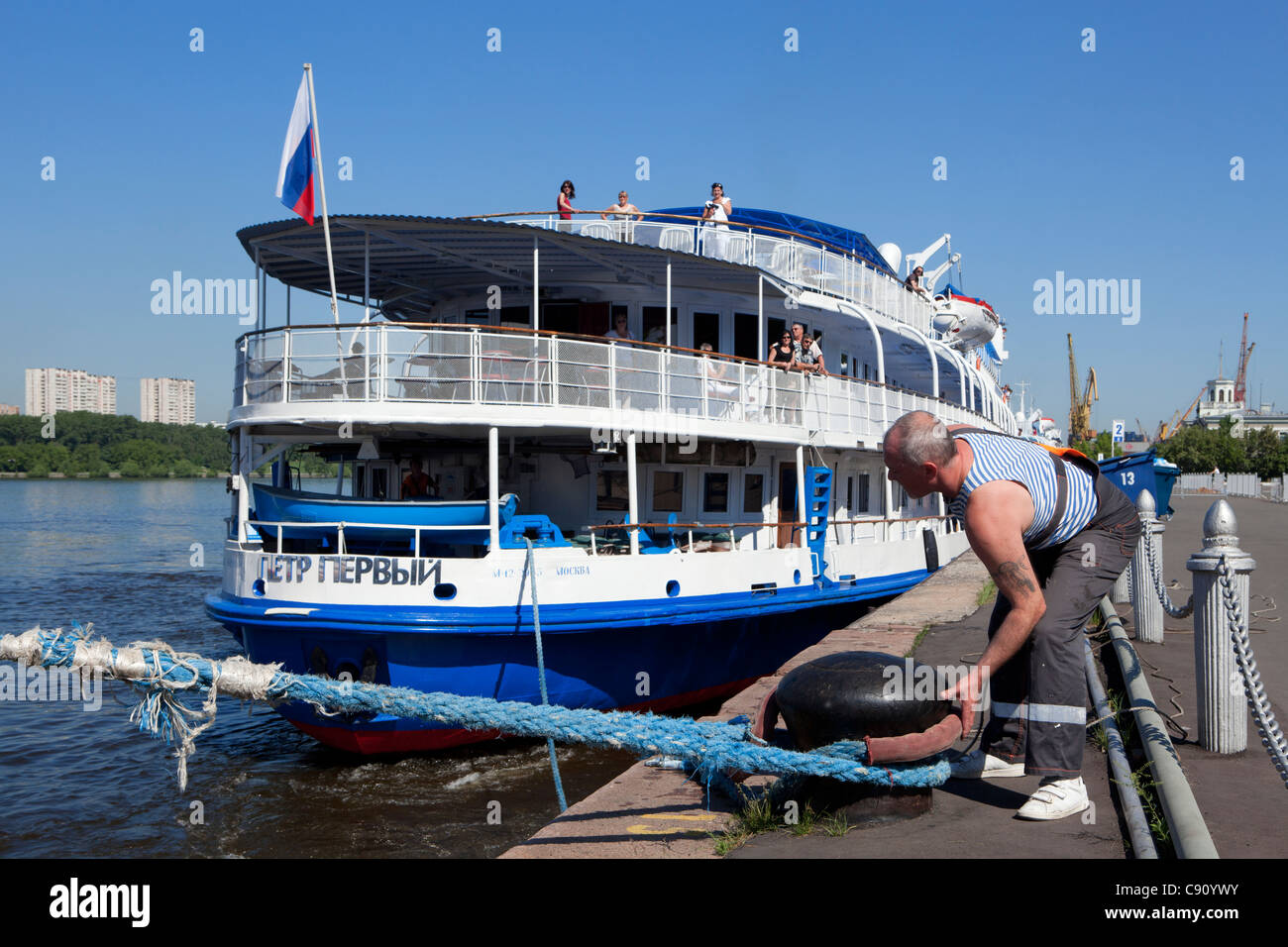 A dockworker securing a mooring line of the riverboat Peter The Great ...