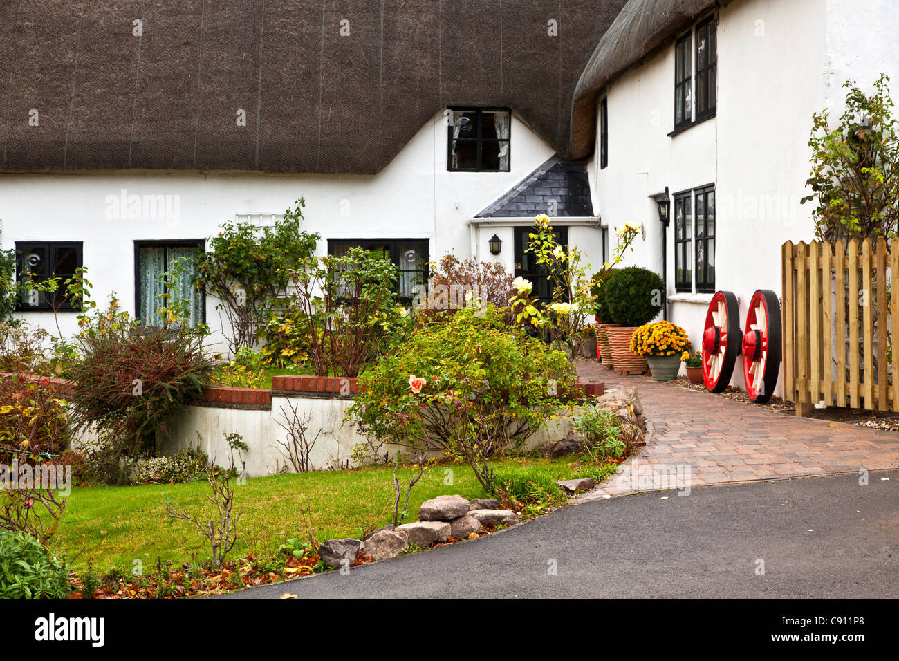 A pretty traditional thatched English country village cottage with ...