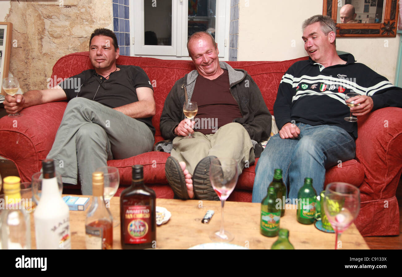 Three middle aged men drinking together Stock Photo - Alamy