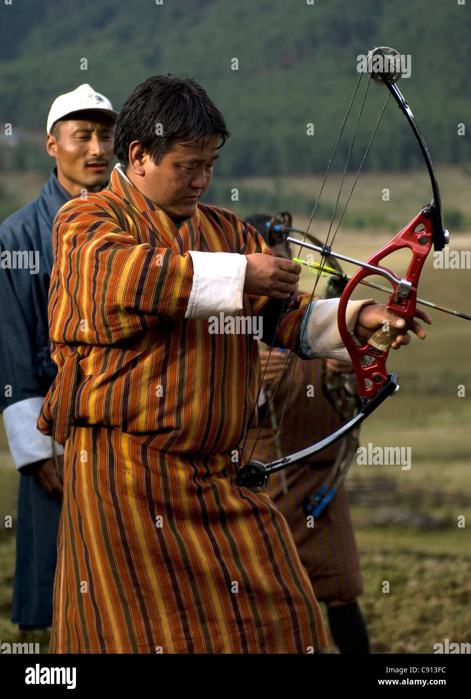 An archer fits an arrow to his bow during a three day inter-village ...