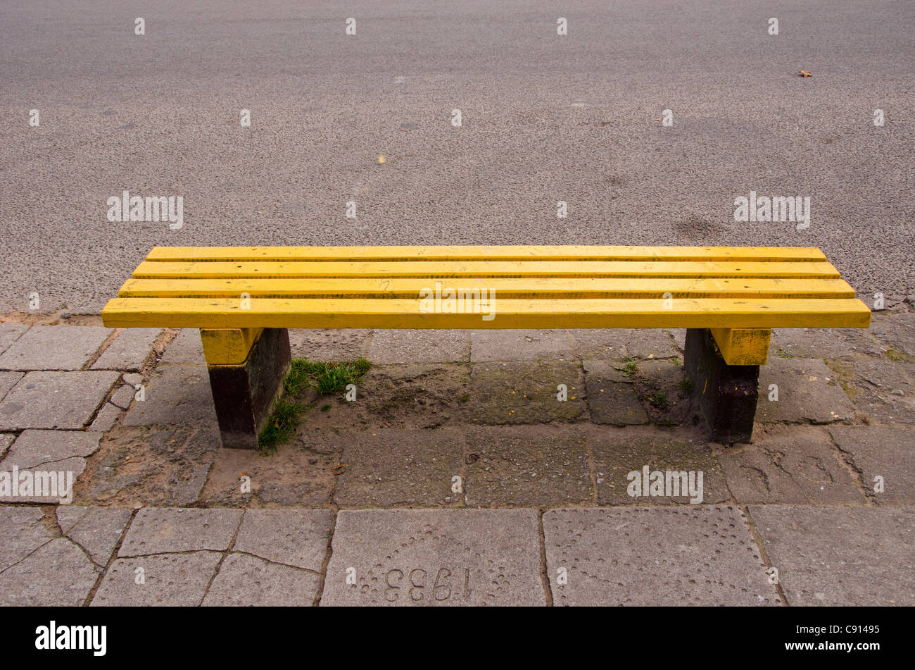 empty yellow bench in the street on pavement Stock Photo - Alamy