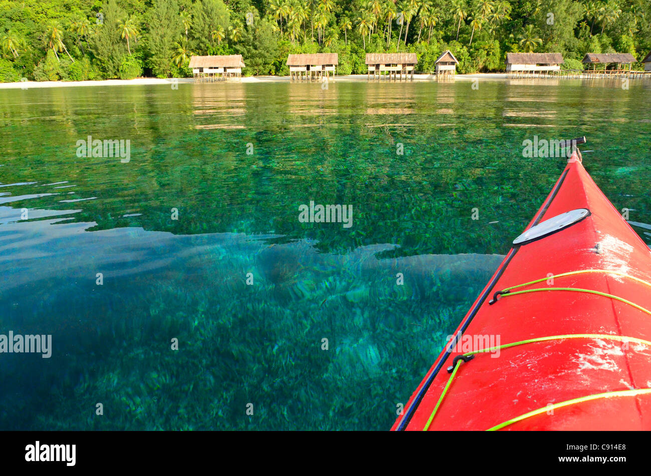 Red canoe over shallow reef, Kree Eco Resort, Raja Ampat islands of ...