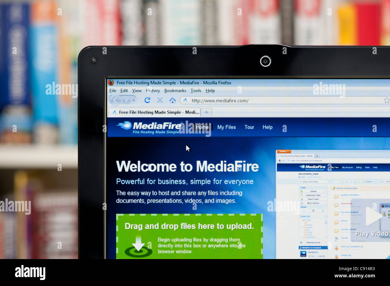 The MediaFire website shot against a bookcase background (Editorial use ...
