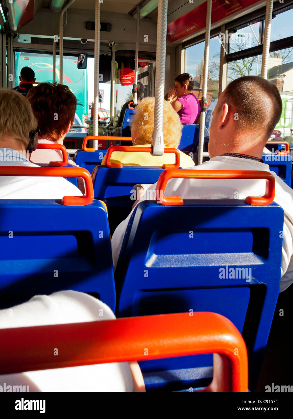 Interior showing passengers on a crowded bus on a sunny day in England ...