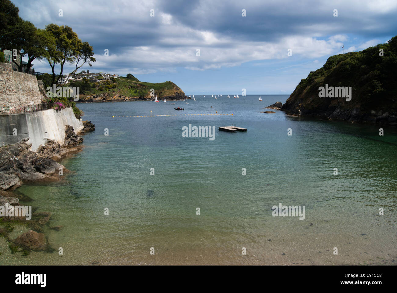 Small bay with swimming pontoon at mouth of River Fowey, Cornwall Stock ...