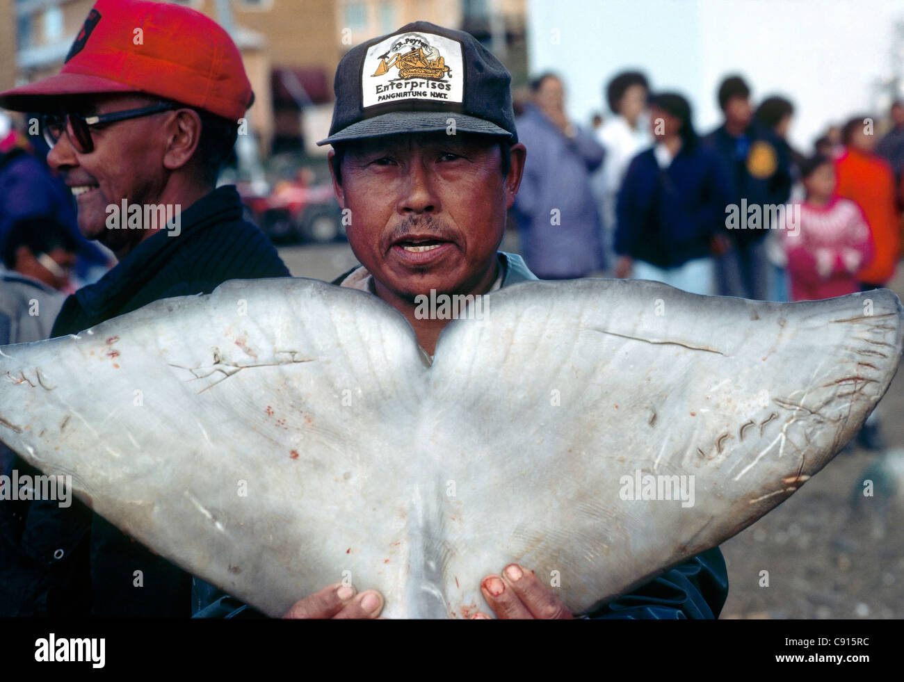 Inuit fisherman with freshly caught Beluga Whale meat for the community ...