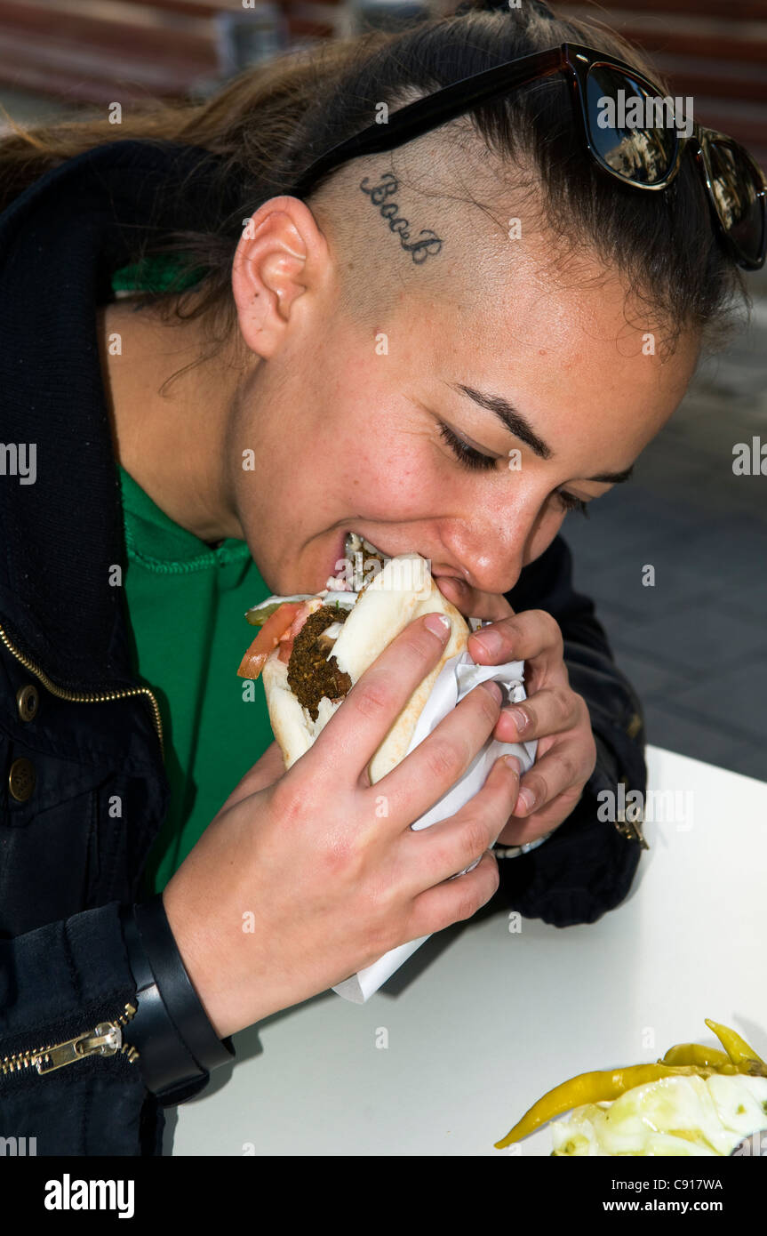 Woman eating falafel hi-res stock photography and images - Alamy