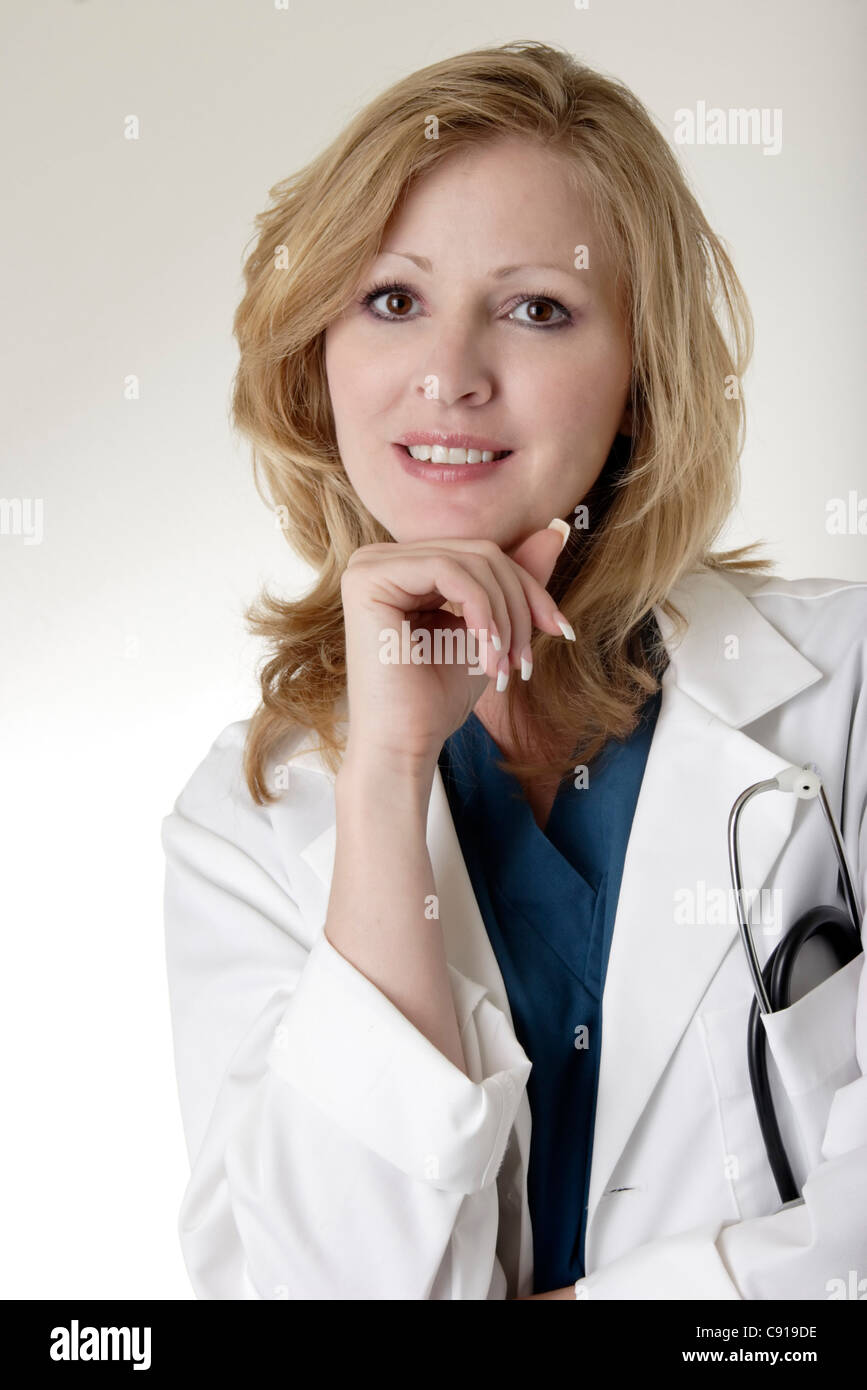 Lady blond Caucasian doctor with hand on chin Stock Photo - Alamy