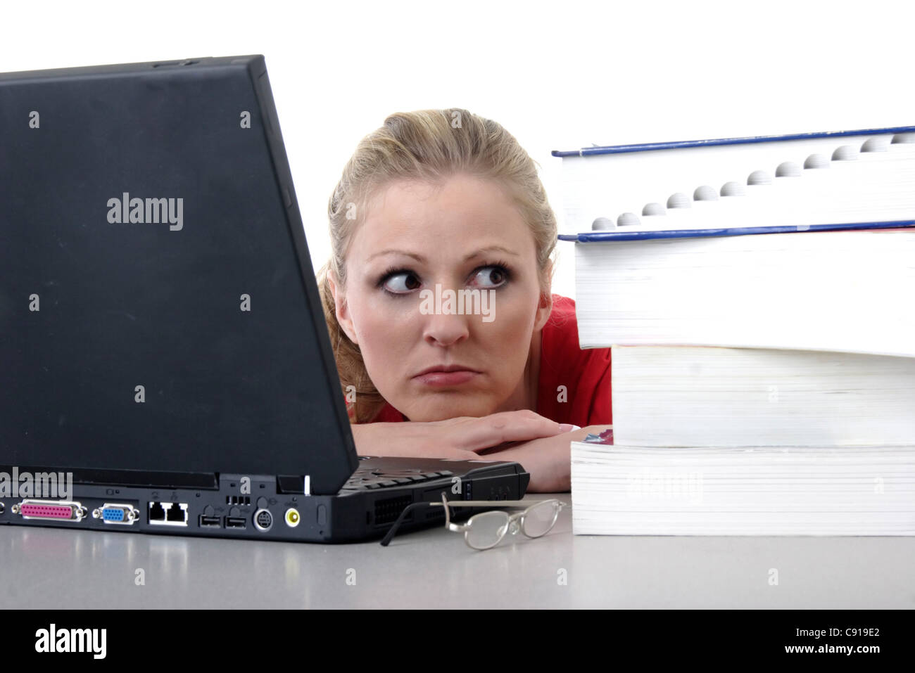 Attractive blond woman leaning on hands on desk in front of laptop ...