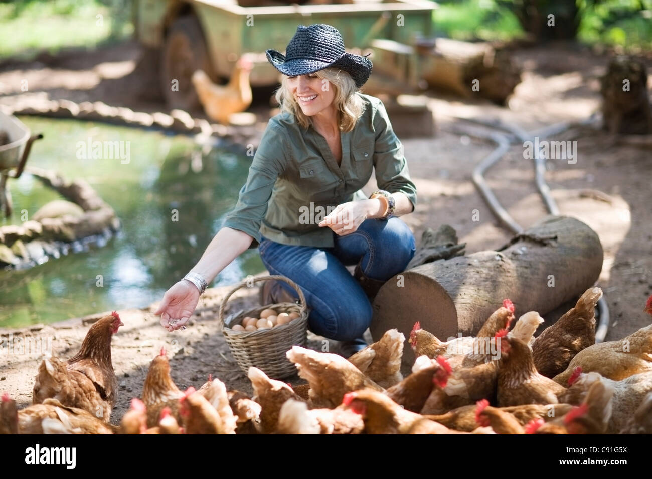 Woman on farm crouching hi-res stock photography and images - Alamy