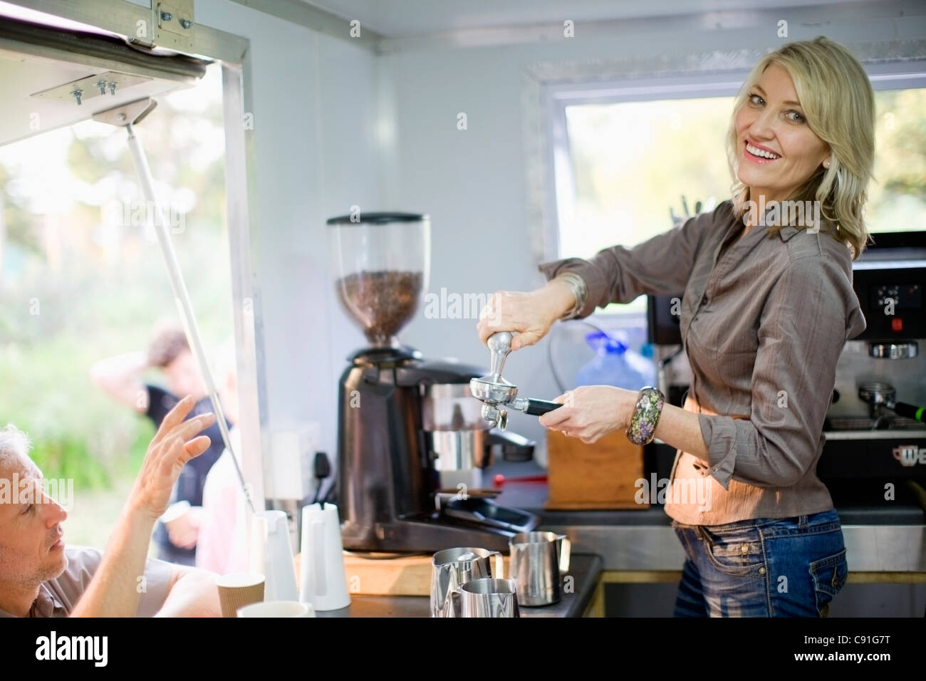 Woman making coffee in food cart Stock Photo - Alamy