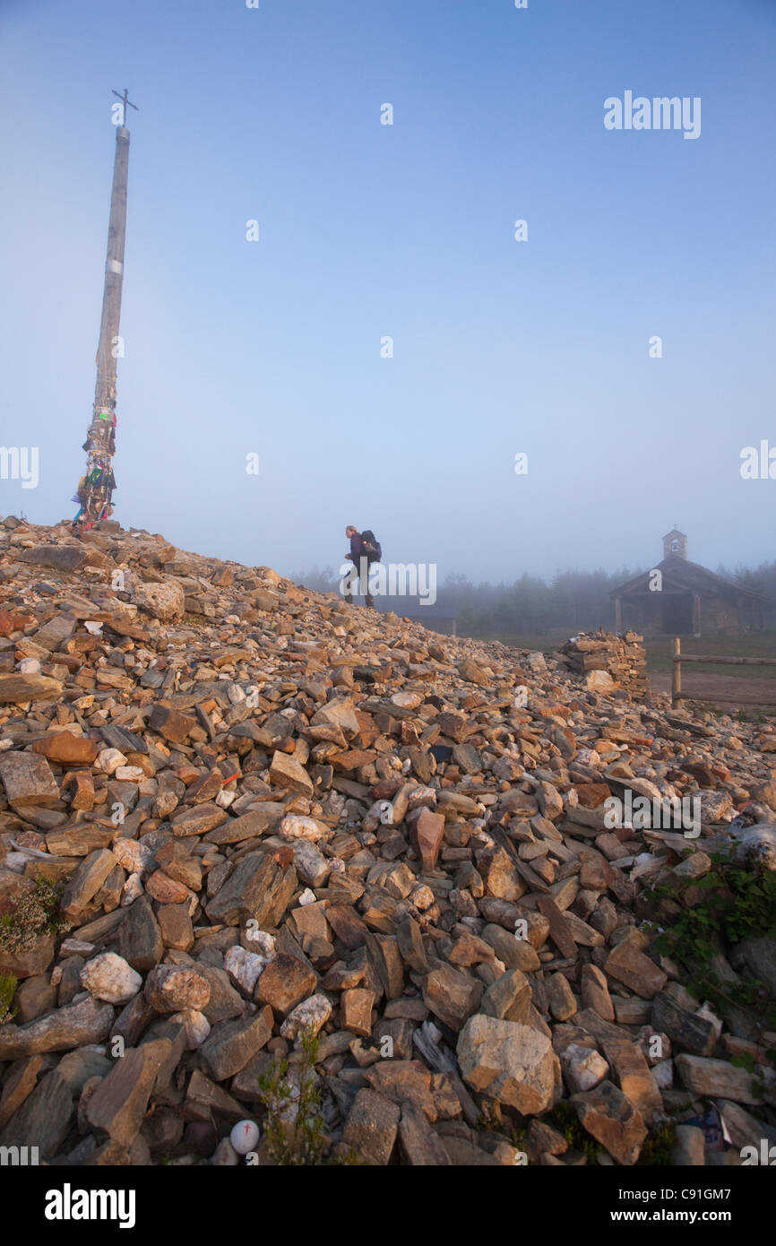 Pilgrim at iron cross Cruz del Ferro Province of Leon Old Castile ...