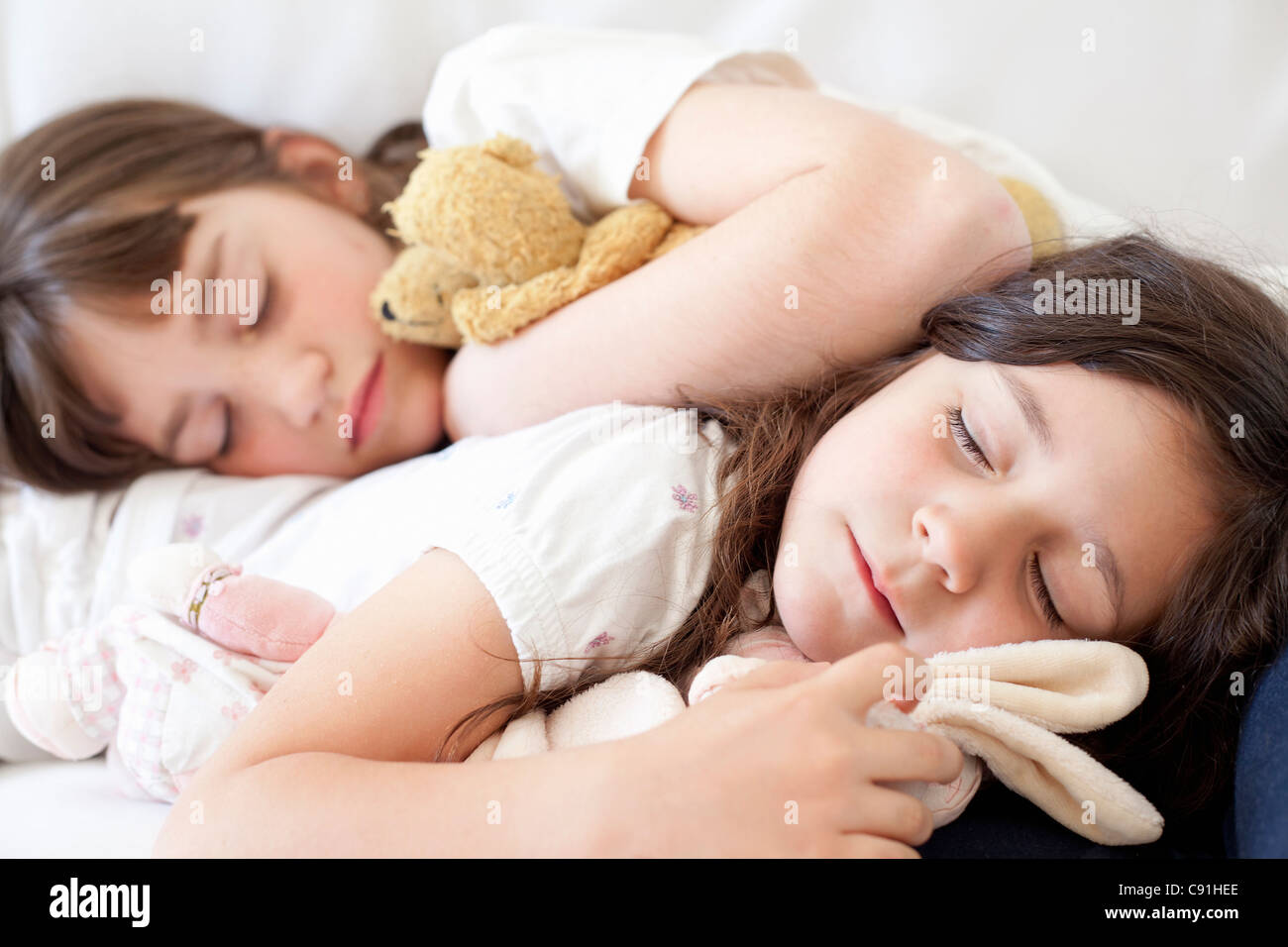 Girls napping on couch together Stock Photo - Alamy