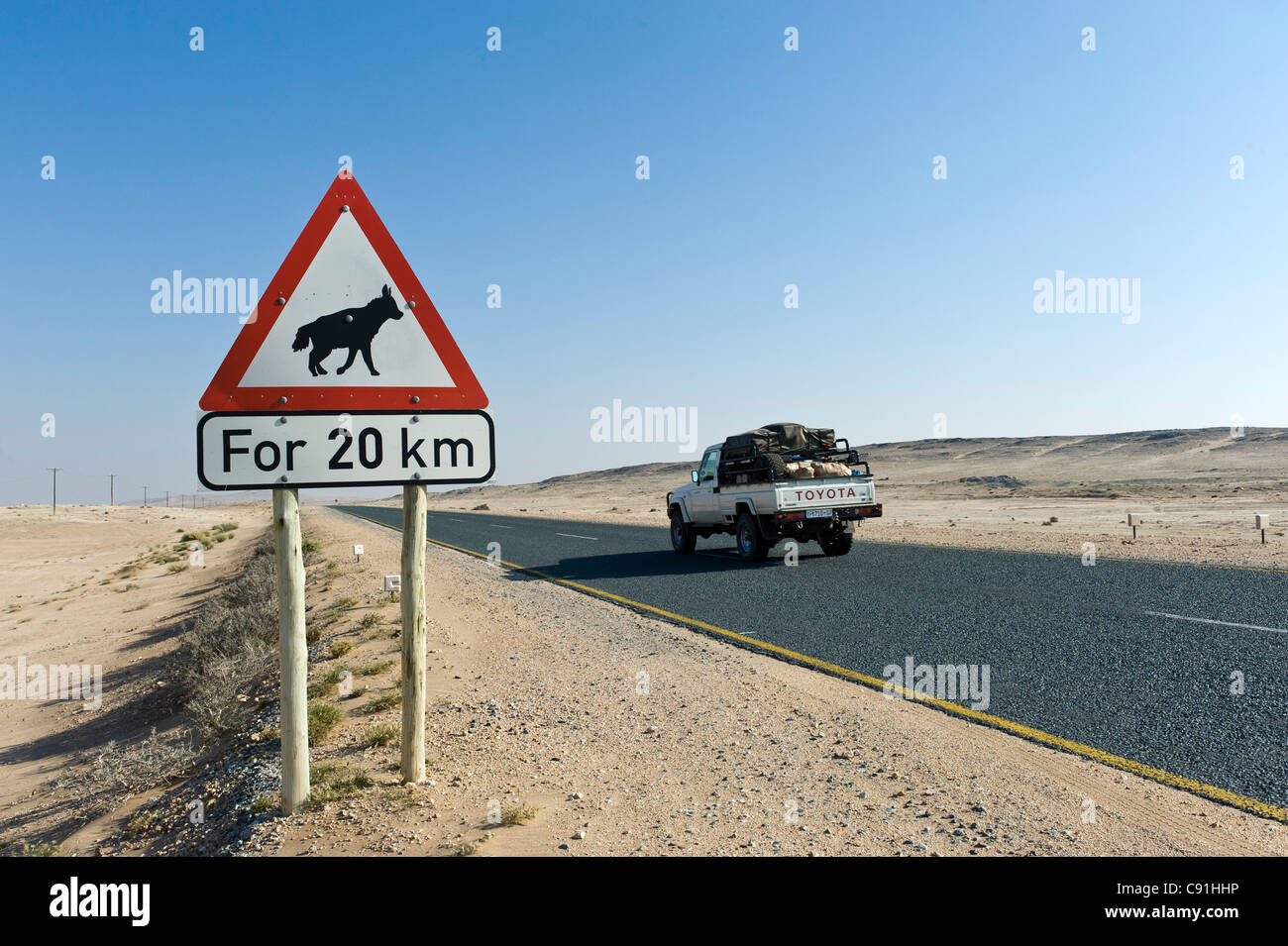Road sign "Be aware of with Hyeana" along a road in southern Namibia ...