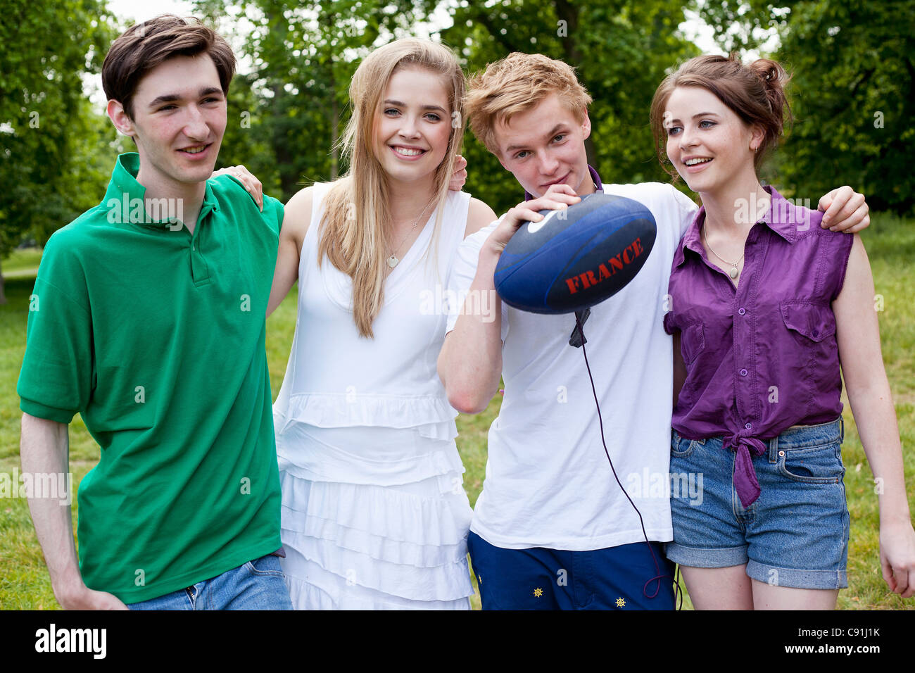 Teenagers standing in park together Stock Photo - Alamy