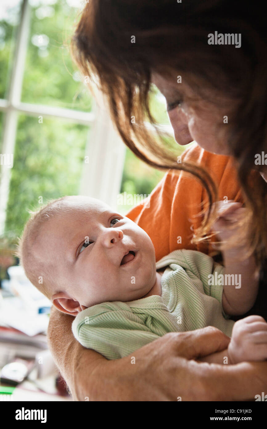 Mother cradling infant Stock Photo - Alamy
