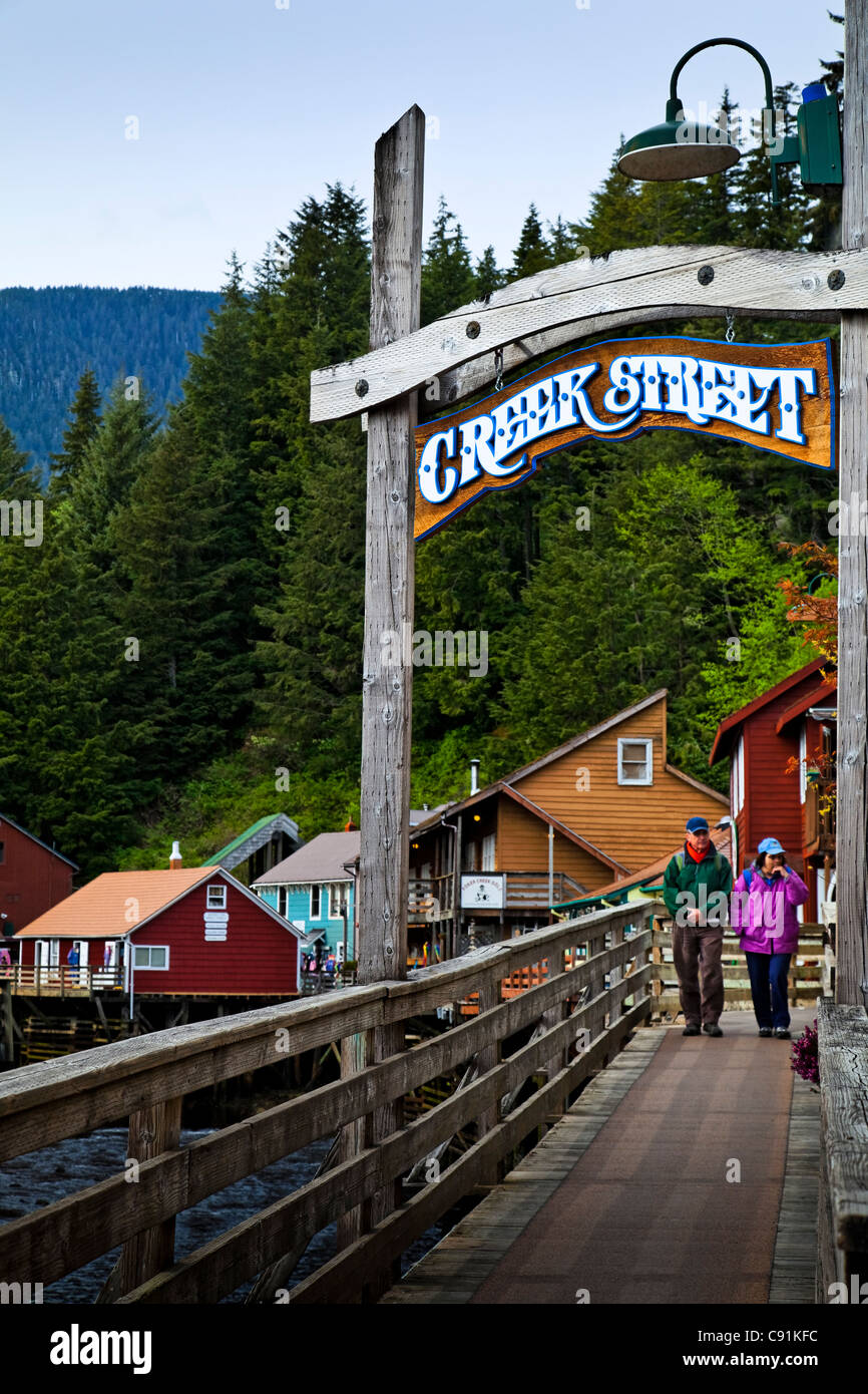 Visitors walk along the historic boardwalk at Creek Street, Ketchikan ...