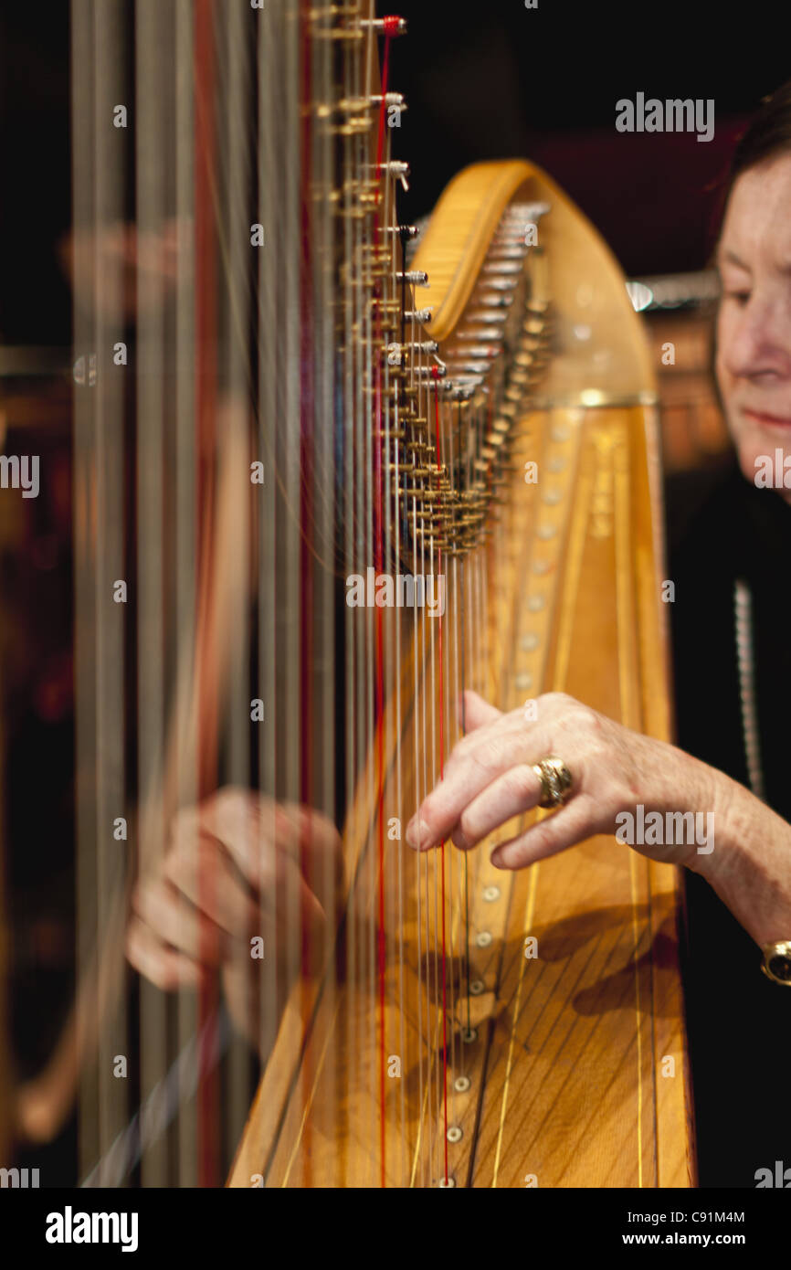 Harp player in orchestra Stock Photo - Alamy