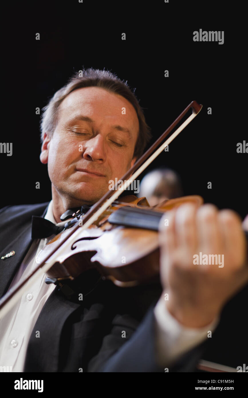 Violin player in orchestra Stock Photo - Alamy