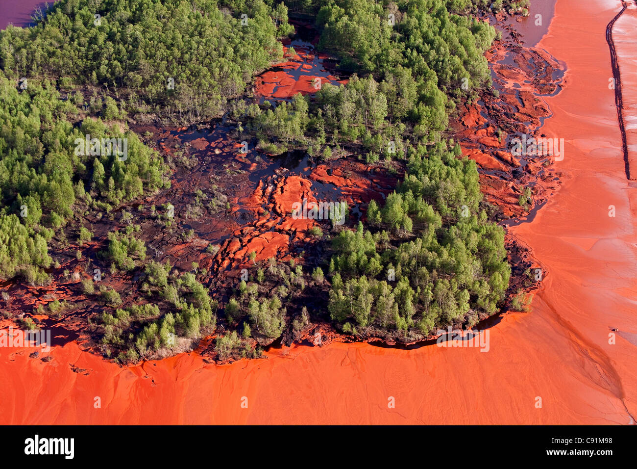 Aerial view of red mud waste product in a holding pond from an ...