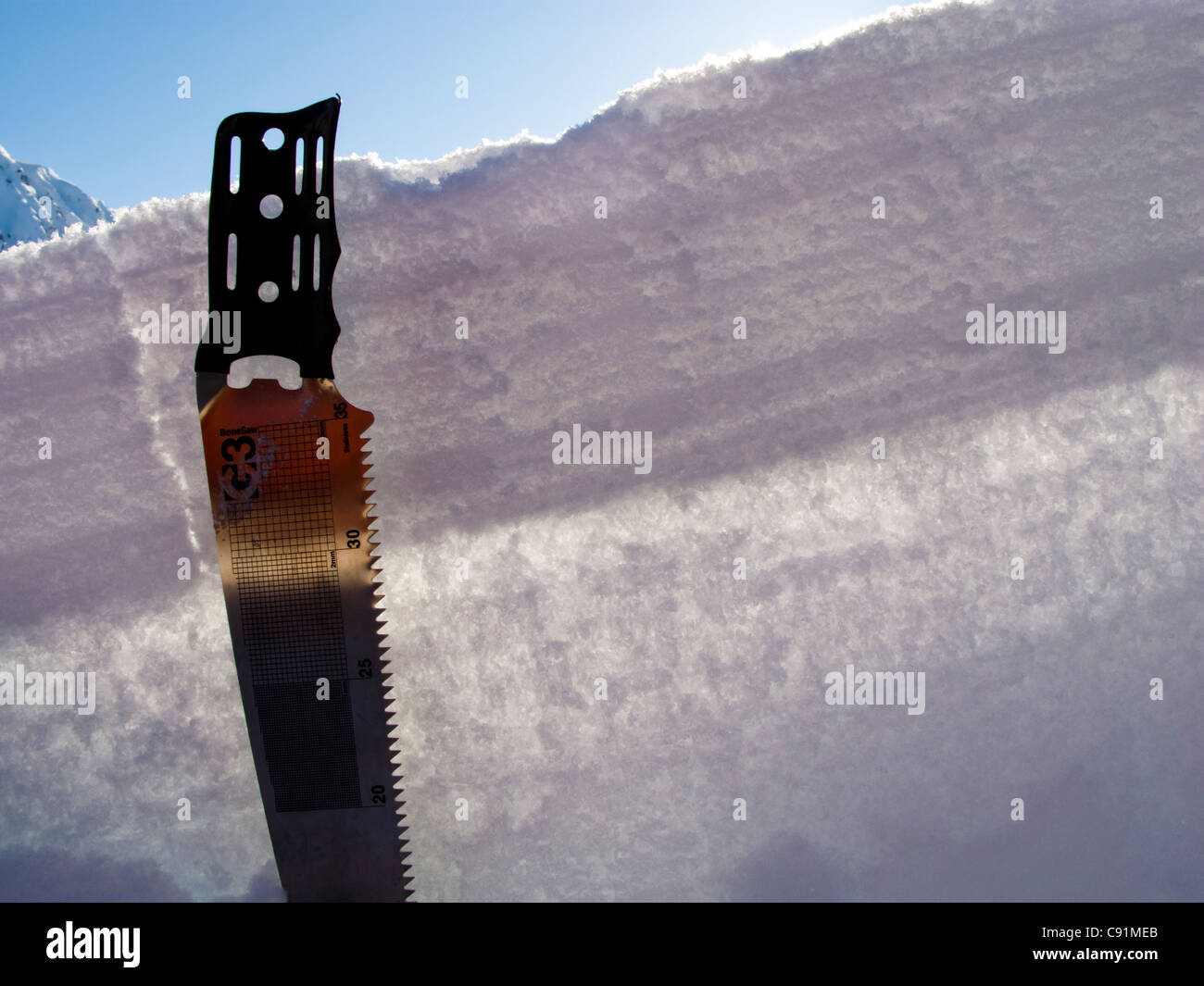 Light shining through a thick section of snowpack cut by a snow saw ...