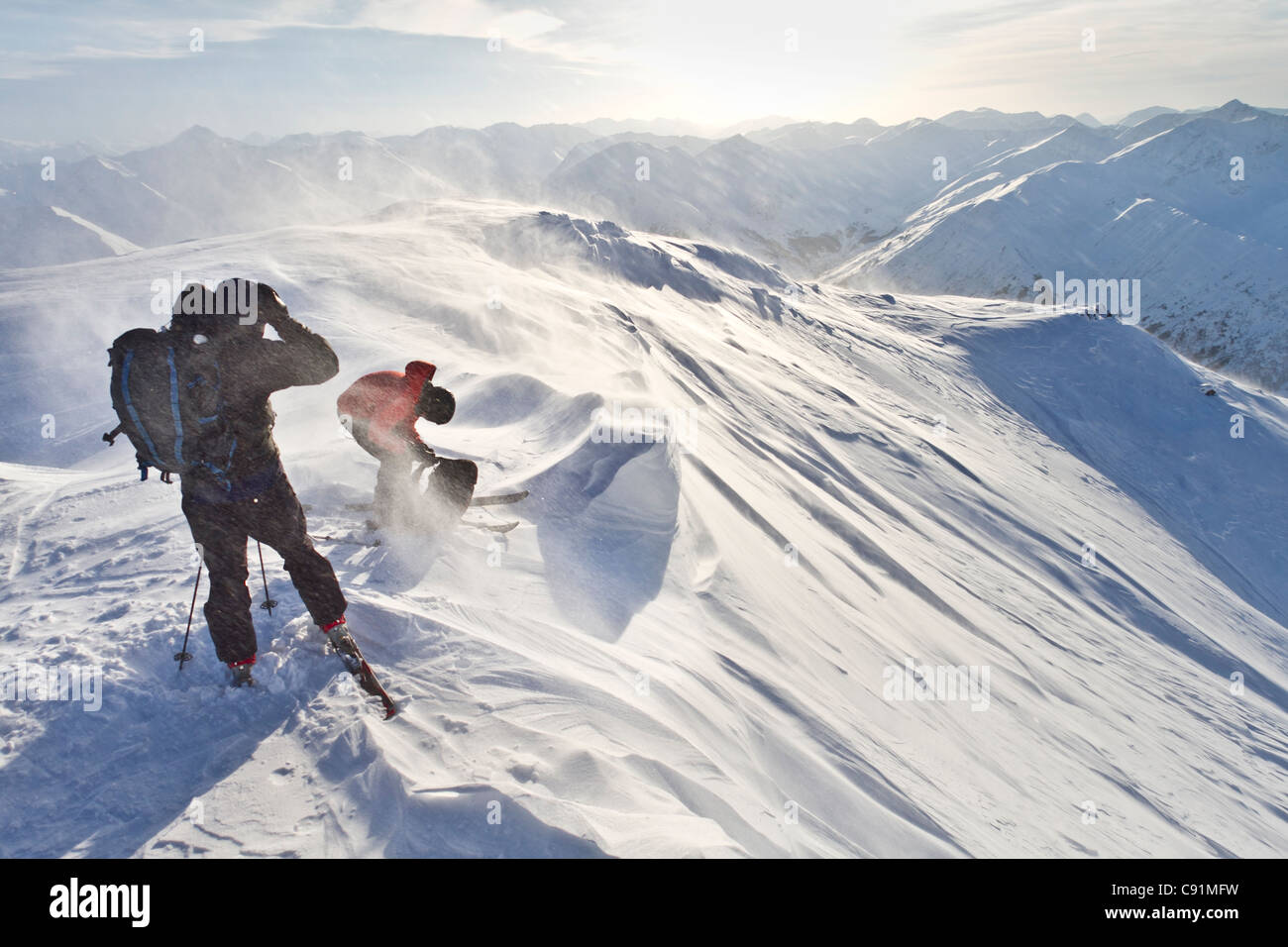 Skiers prepare to ski down Peak 4940 in high wind and blowing snow ...