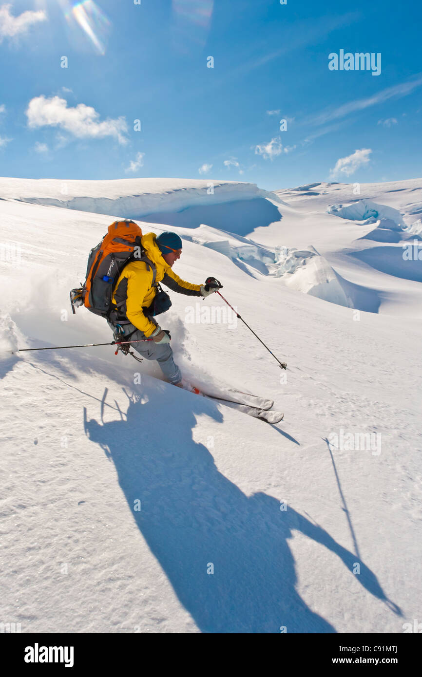 Backpacker skiing powder on Trimble Glacier, Tordrillo Mountains ...