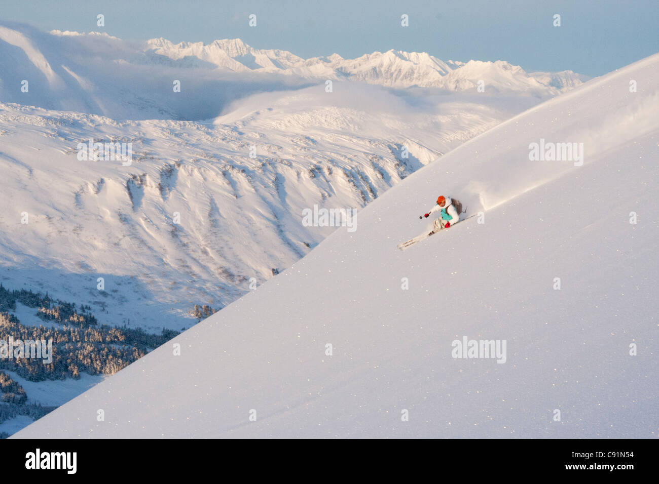 Downhill skier in fresh powder in Chugach Mountains of Turnagain Pass ...