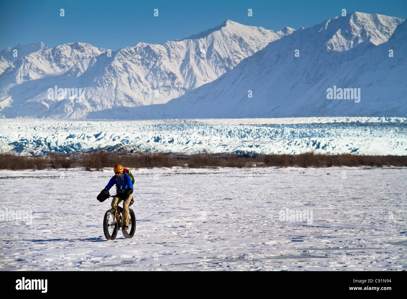 Man Fat Tire mountain biking on the Knik Glacier, Chugach Mountains ...