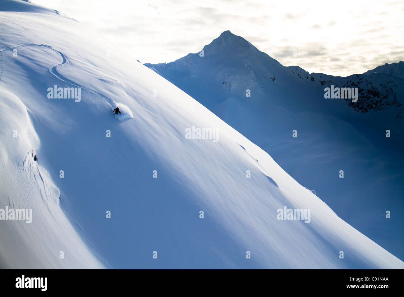 Man backcountry skiing in powder snow at Wolverine Bowl, Turnagain Pass ...
