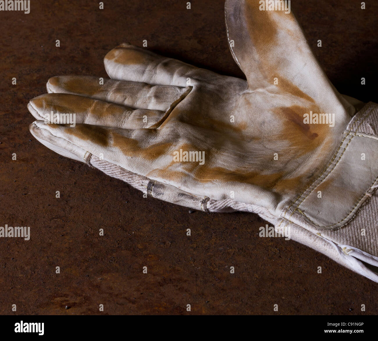 detail of a dirty working glove in rusty back Stock Photo - Alamy