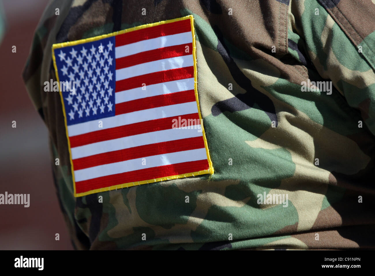 An American Flag patch sewn to the back of a camouflage jacket Stock ...