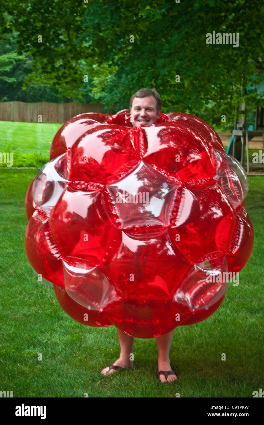 Family activity, playing with large geodesic style inflatable ball ...