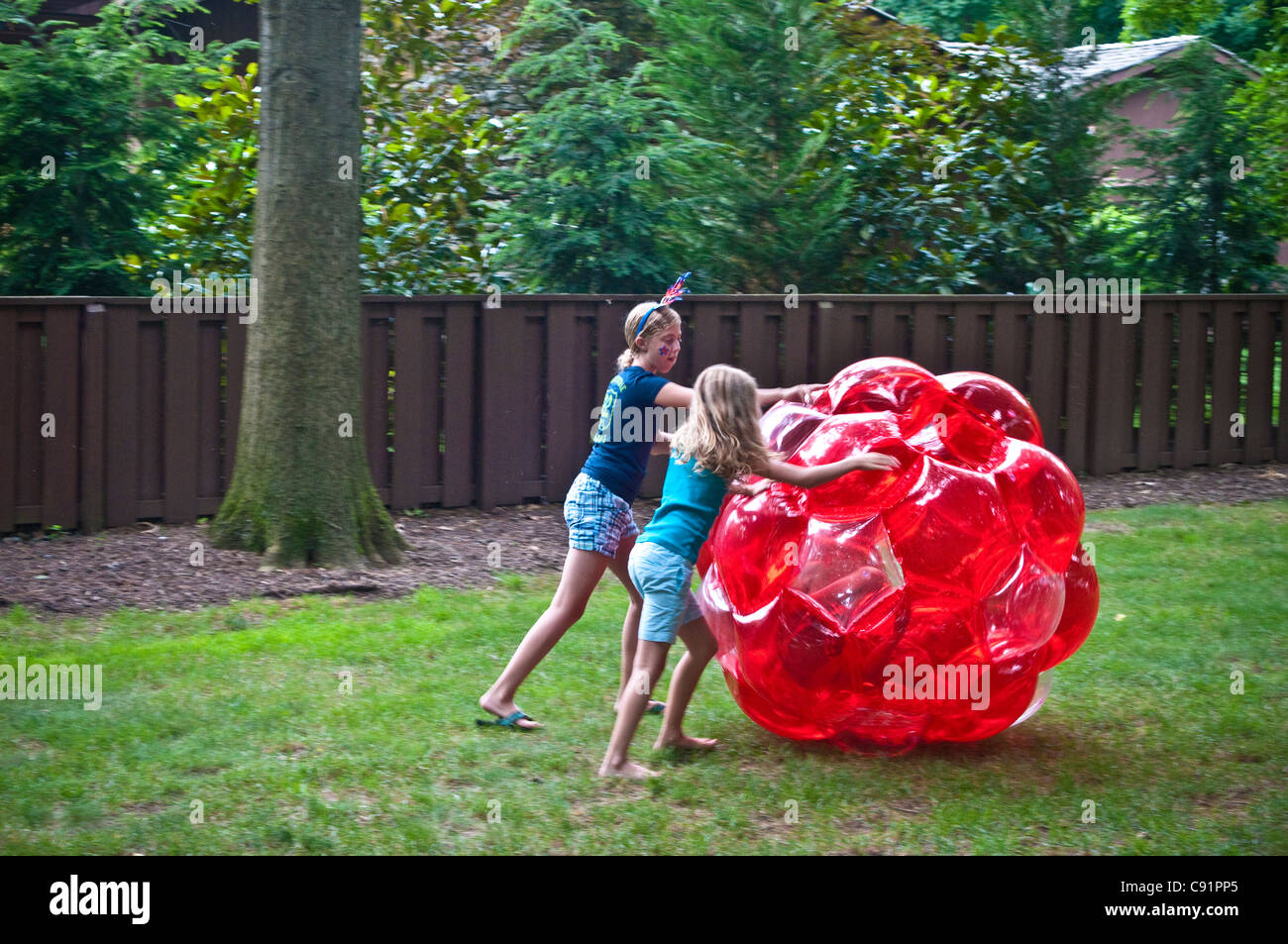 Family activity, playing with large geodesic style inflatable ball ...