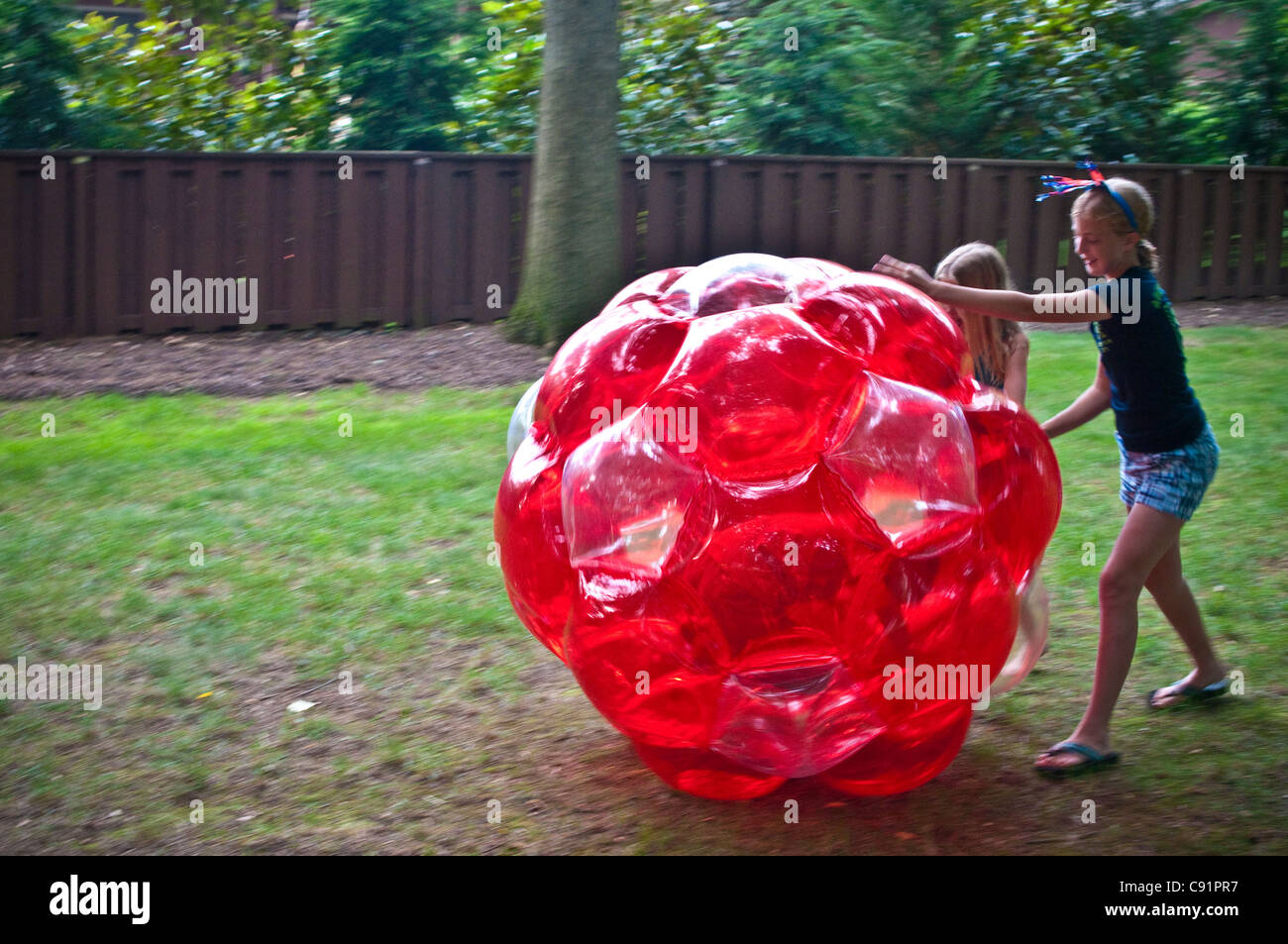 Family activity, playing with large geodesic style inflatable ball ...