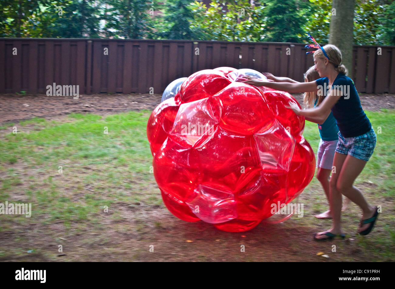 Family activity, playing with large geodesic style inflatable ball ...