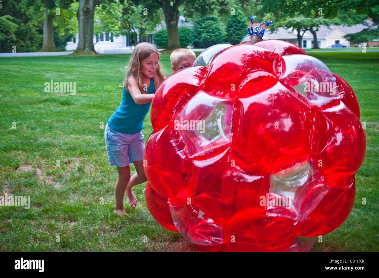 Family activity, playing with large geodesic style inflatable ball ...