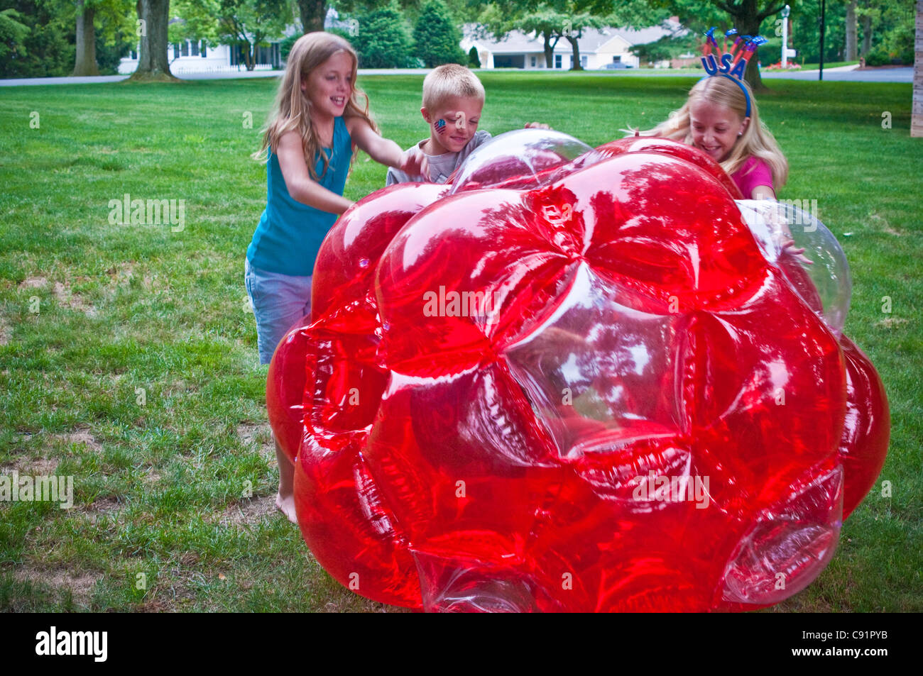 Family activity, playing with large geodesic style inflatable ball ...