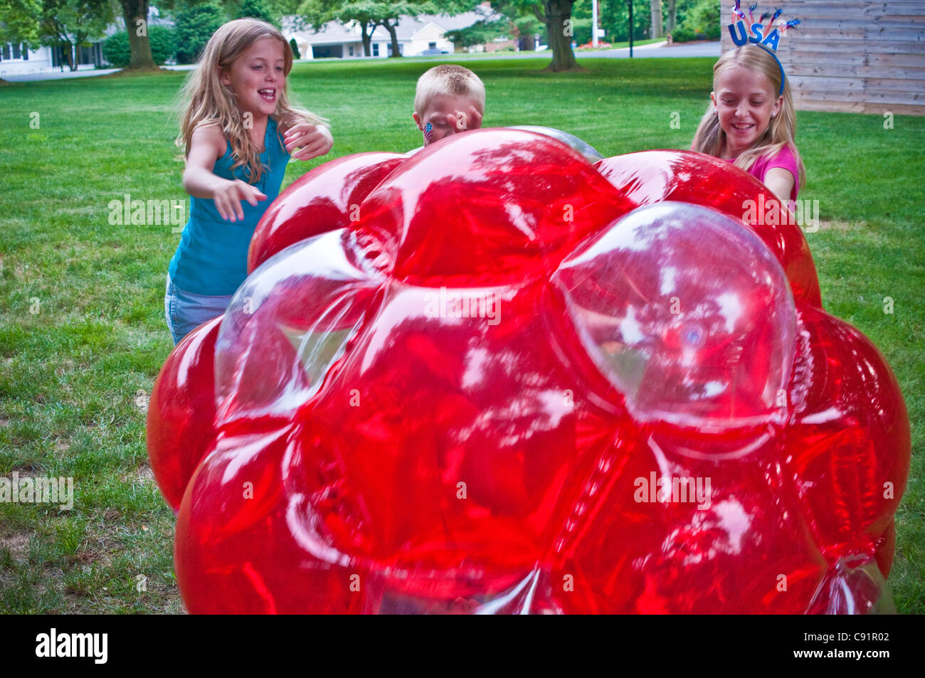 Family activity, playing with large geodesic style inflatable ball ...
