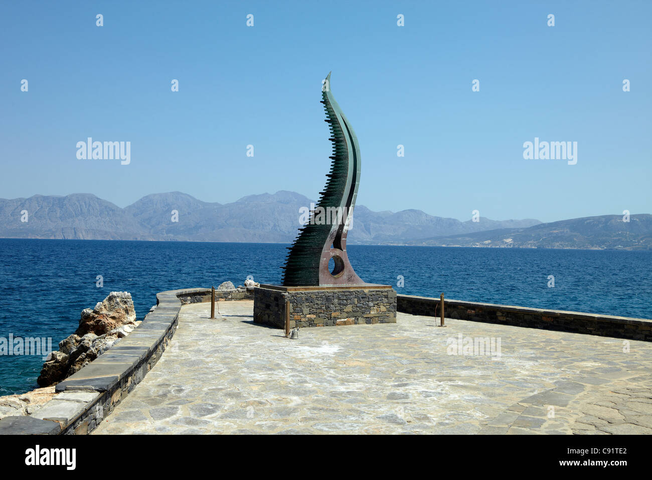 There is a modern glass & copper structure located at the waterfront ...