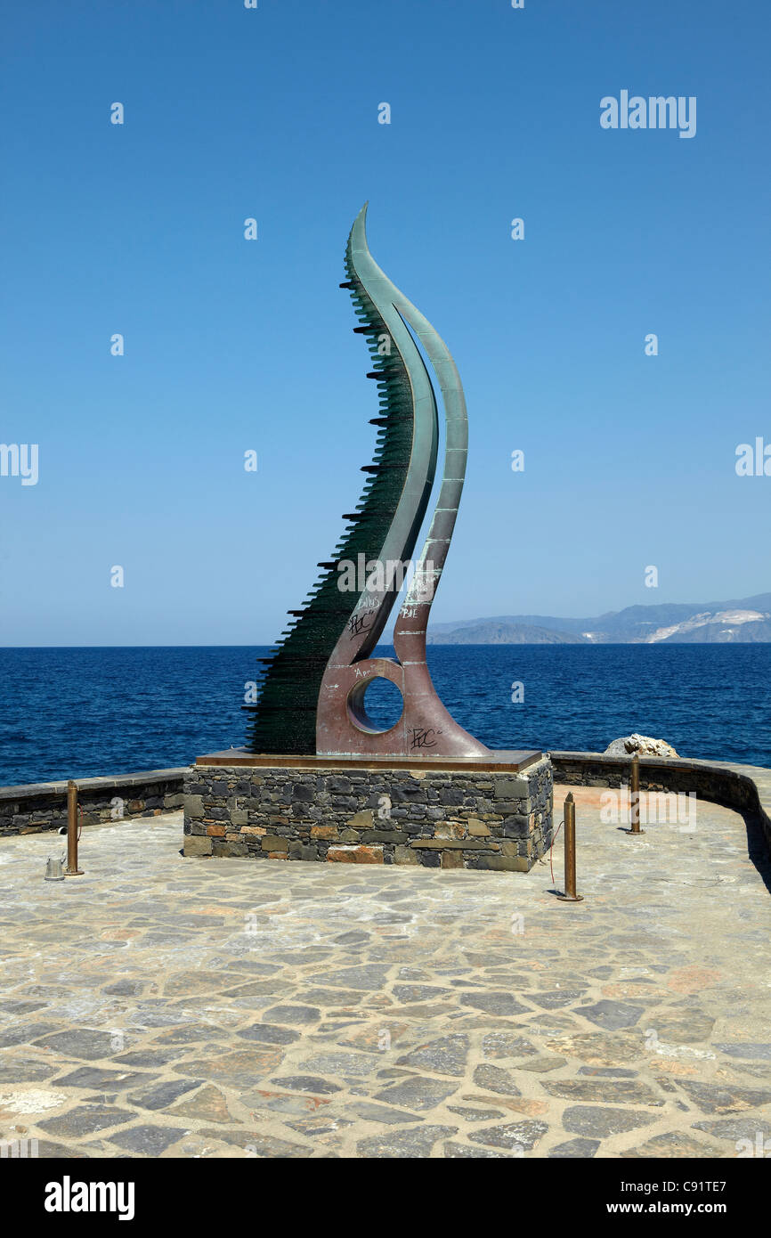 There is a modern glass & copper structure located at the waterfront ...