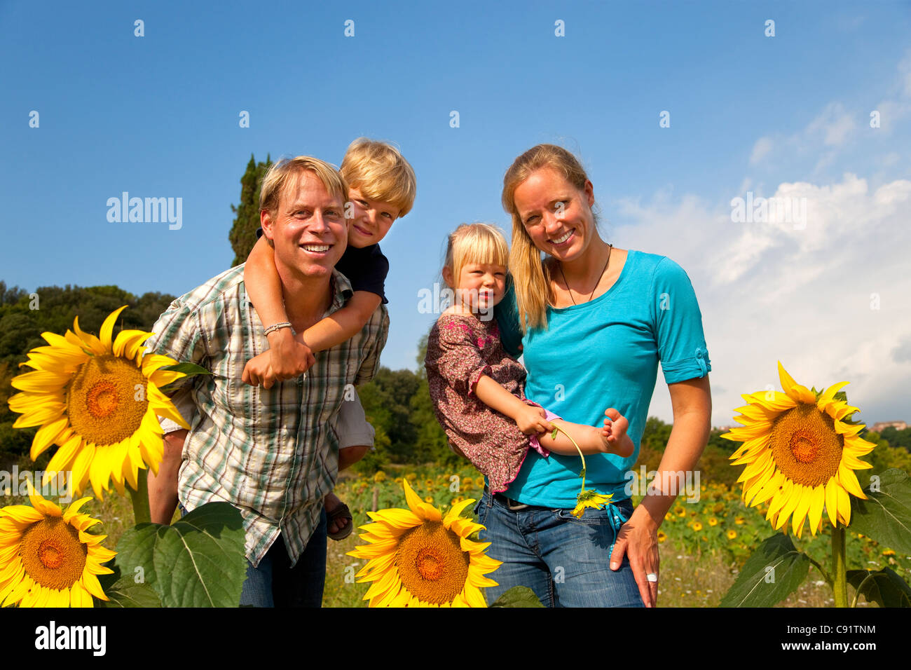 Family walking in field of flowers Stock Photo - Alamy