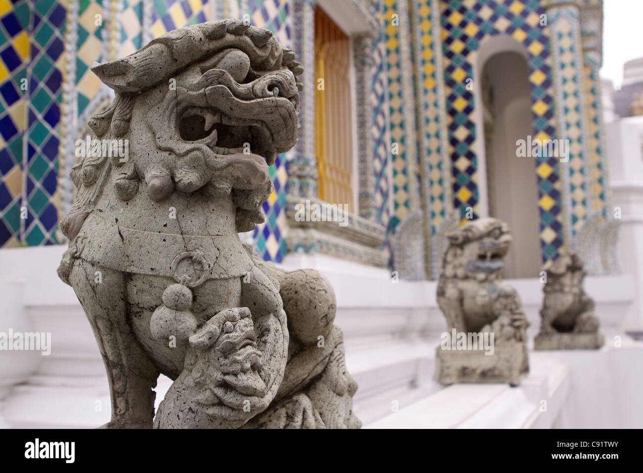 Chinese stone Foo dogs stand guard outside many of the buildings in the ...