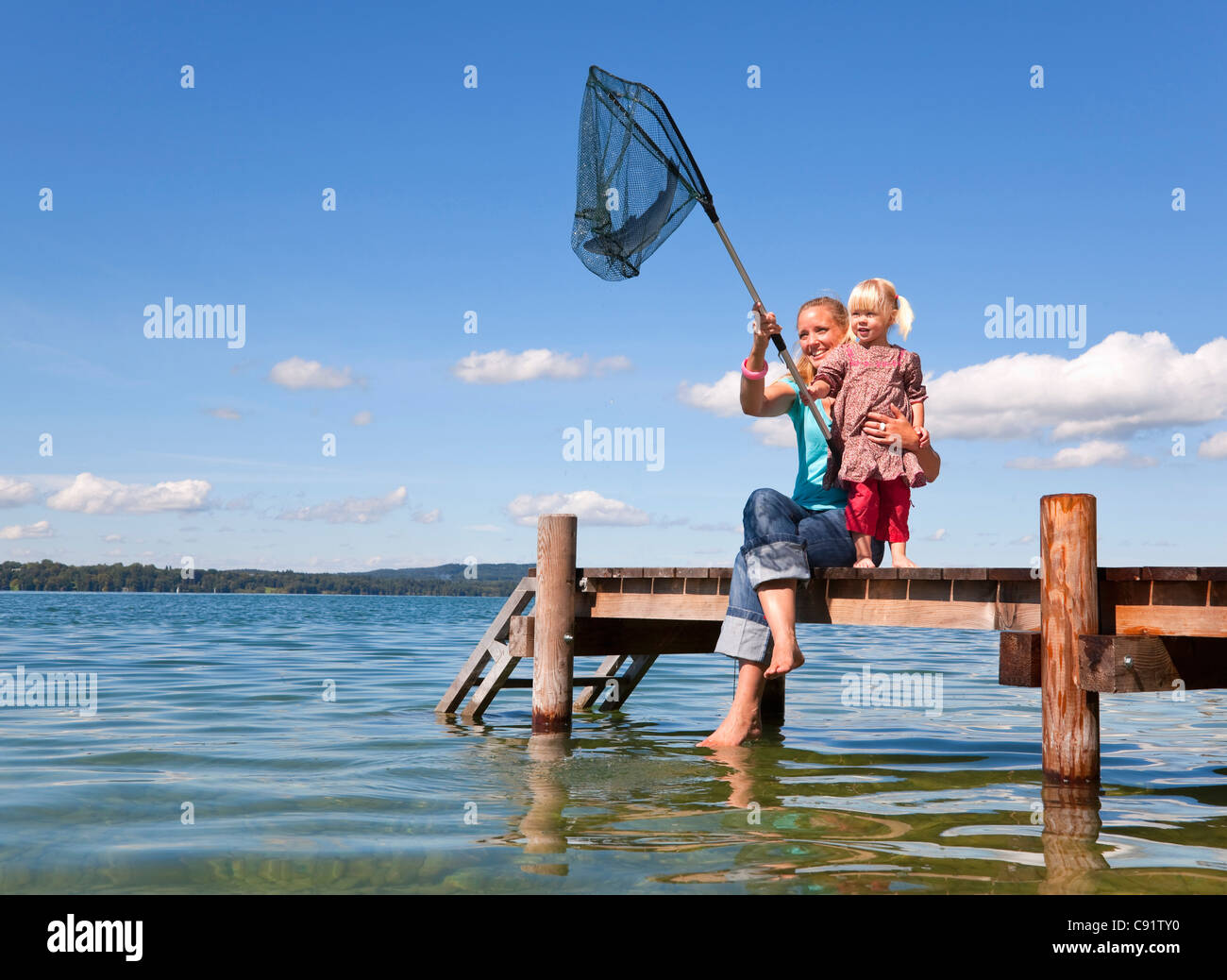 Mother and daughter fishing with net Stock Photo - Alamy
