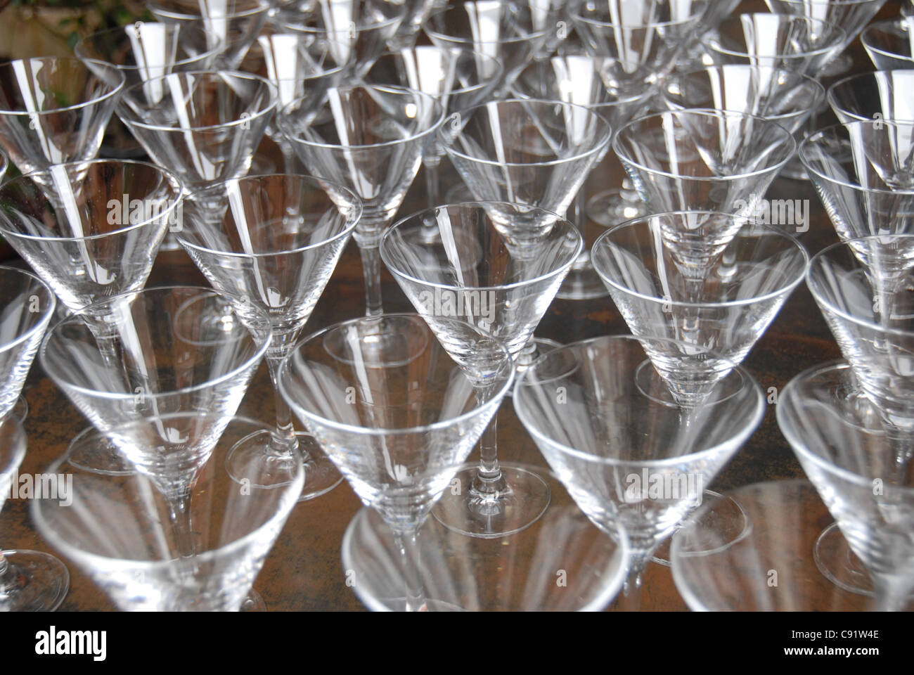Rows of empty cocktail glasses awaiting filling Stock Photo - Alamy