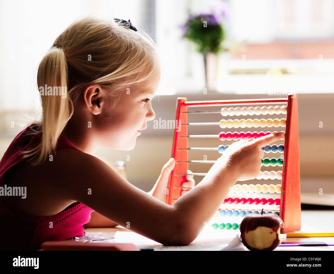 Girl using abacus at desk Stock Photo - Alamy